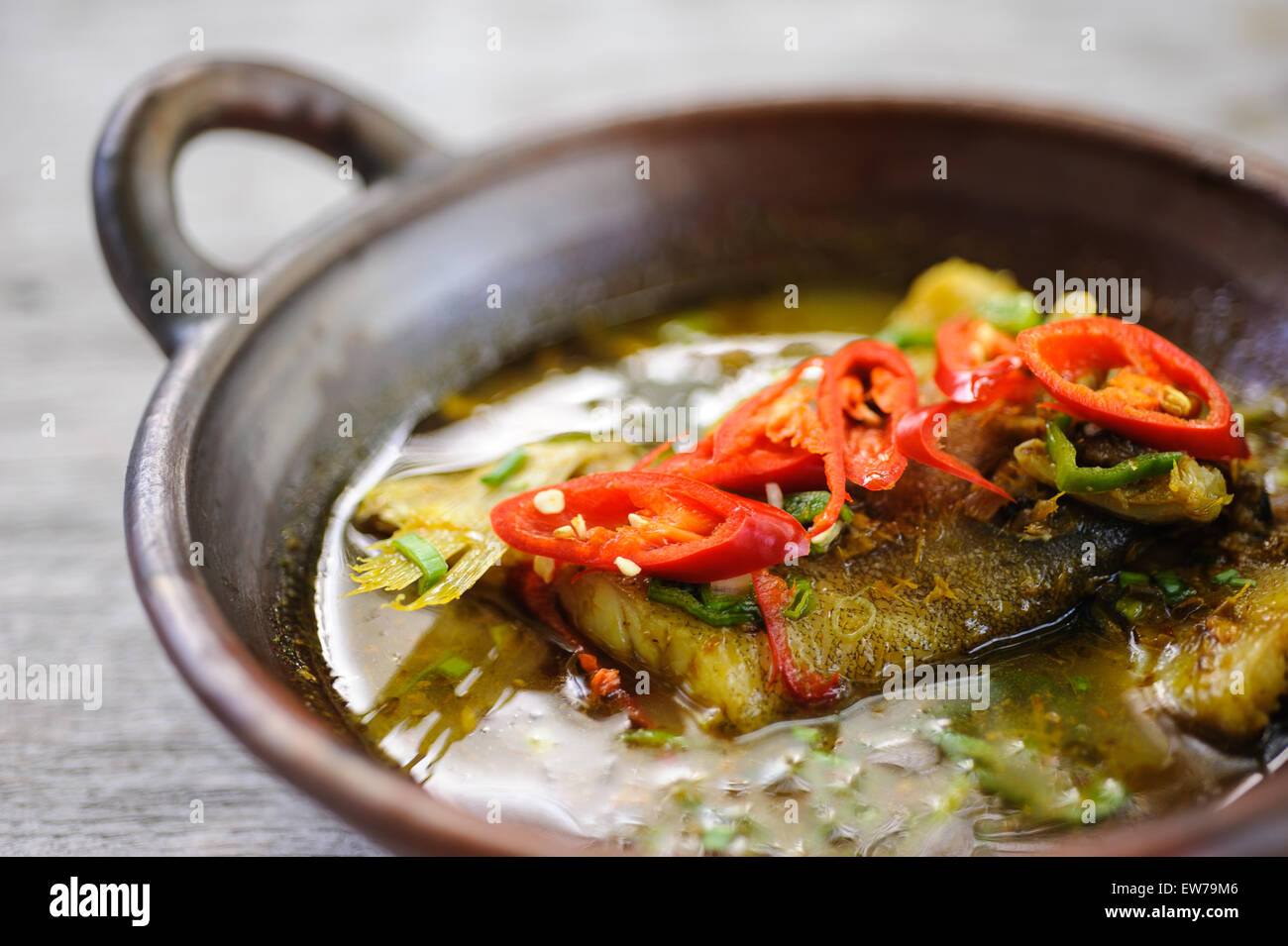 Indonesian style fish curry garnished with red chillies Stock Photo - Alamy