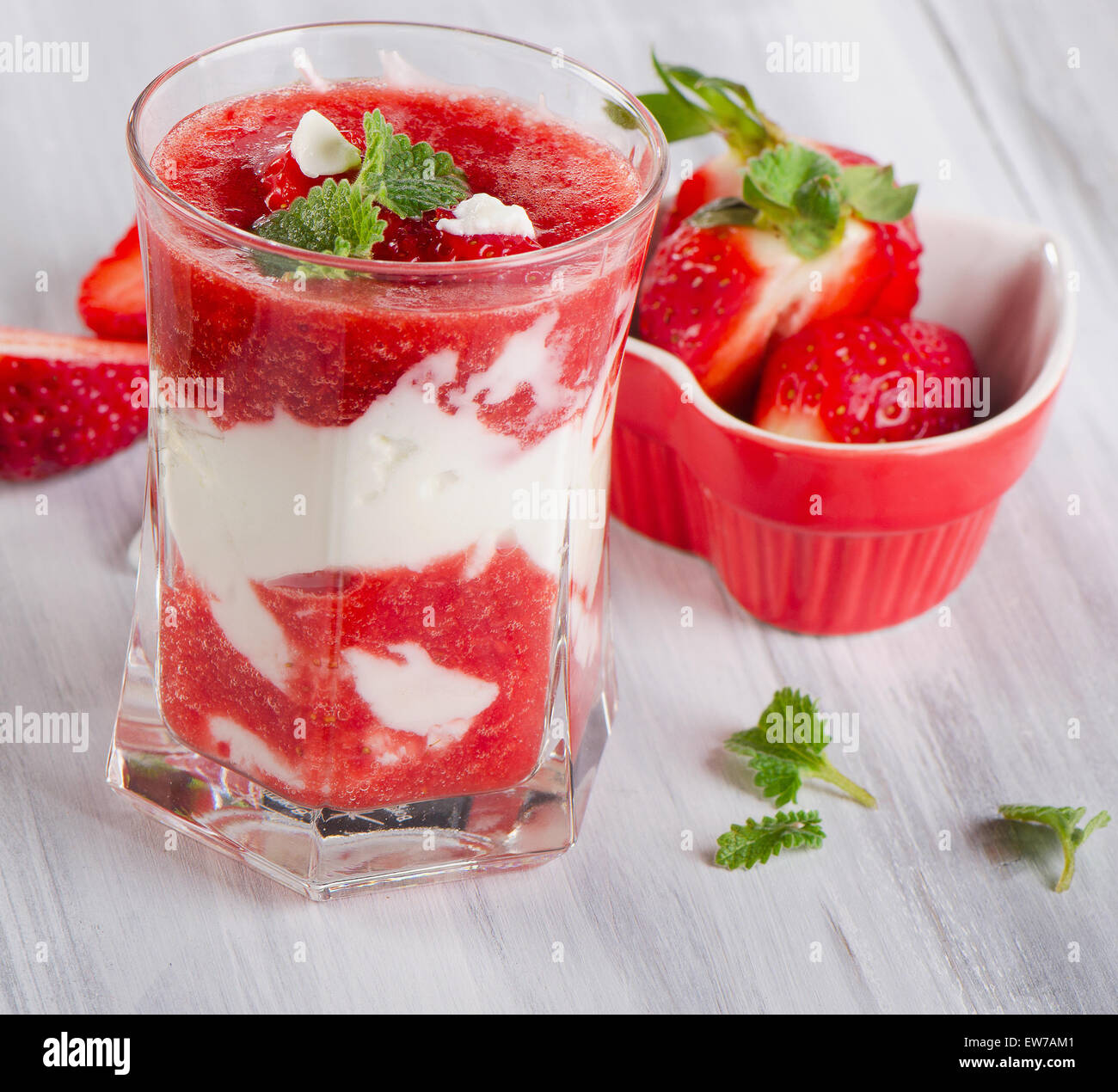 Layered sweet Dessert with strawberries and mint leaves. Selective ...