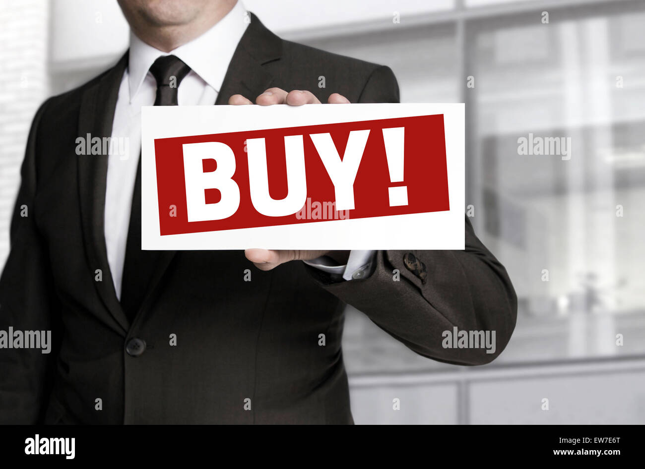 Buy sign is held by businessman Stock Photo - Alamy