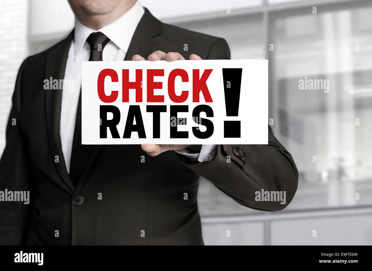 Check Rates sign is held by businessman Stock Photo - Alamy