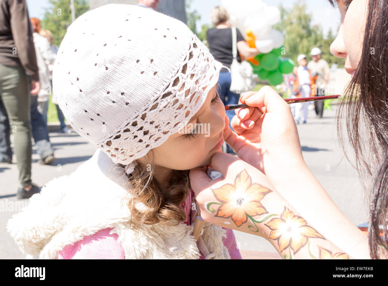 Young girl aged 5 having her face painted in Ufa as part of the Russian ...