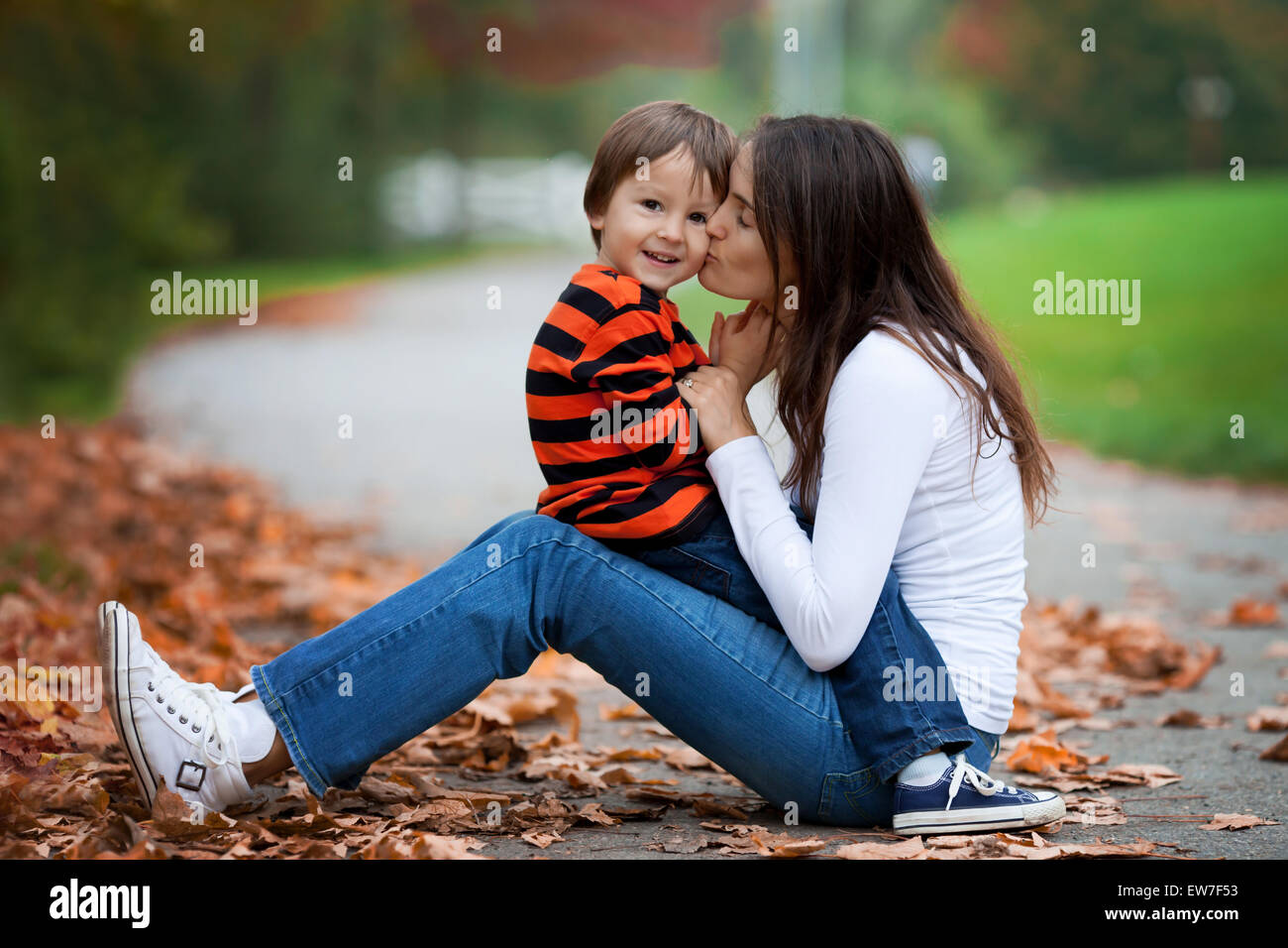 Kid playing isolated portrait. Young mother her boy outdoor in the park Stock Photo - Alamy