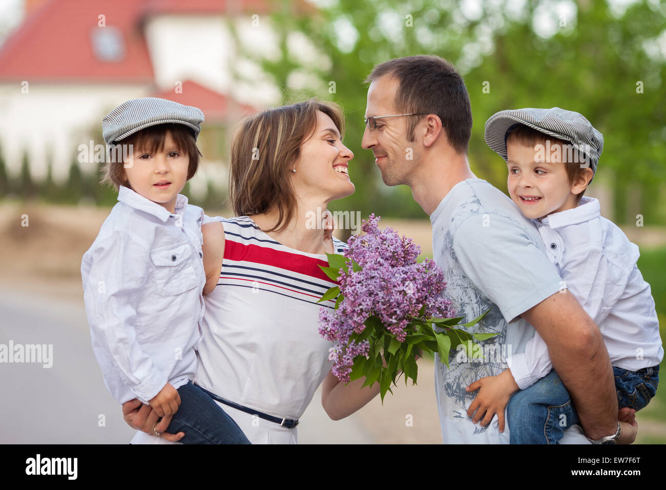 Family of four, mother, father and two boys, parent having the kids on ...