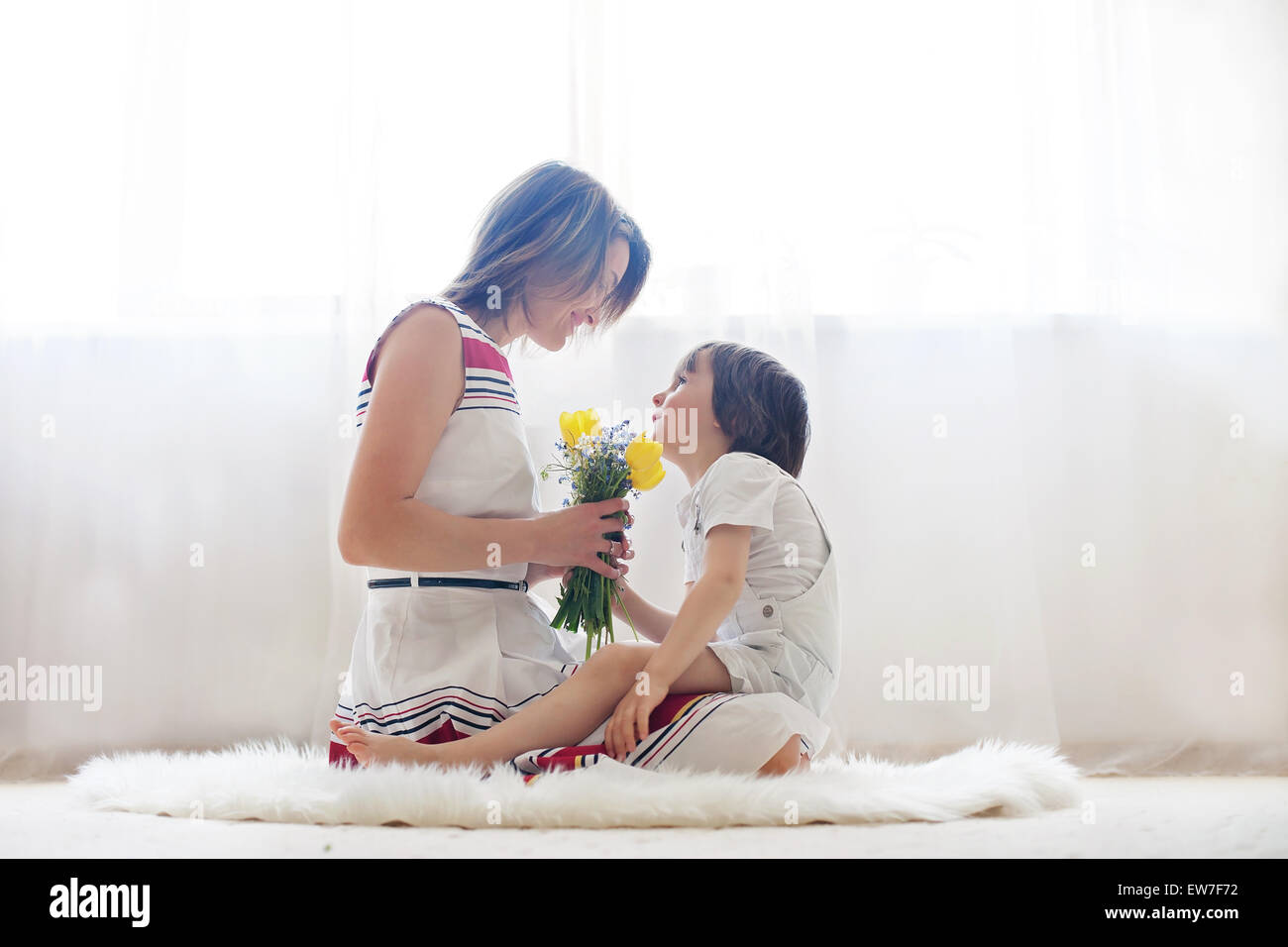 Mother and her child, embracing with tenderness and care, child giving ...