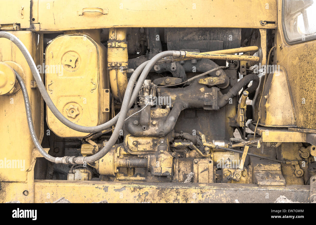 Close-up of a engine compartment of a yellow industrial earth excavator ...