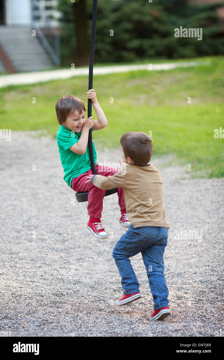 Kids, playing on the playground, having fun Stock Photo - Alamy