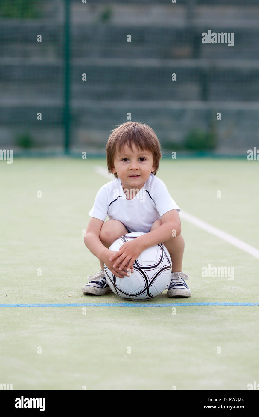 Cute little boy, playing football Stock Photo - Alamy