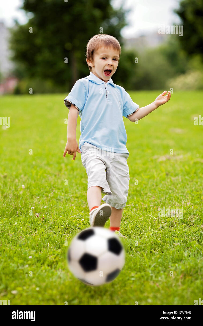 Cute little boy, playing football Stock Photo - Alamy