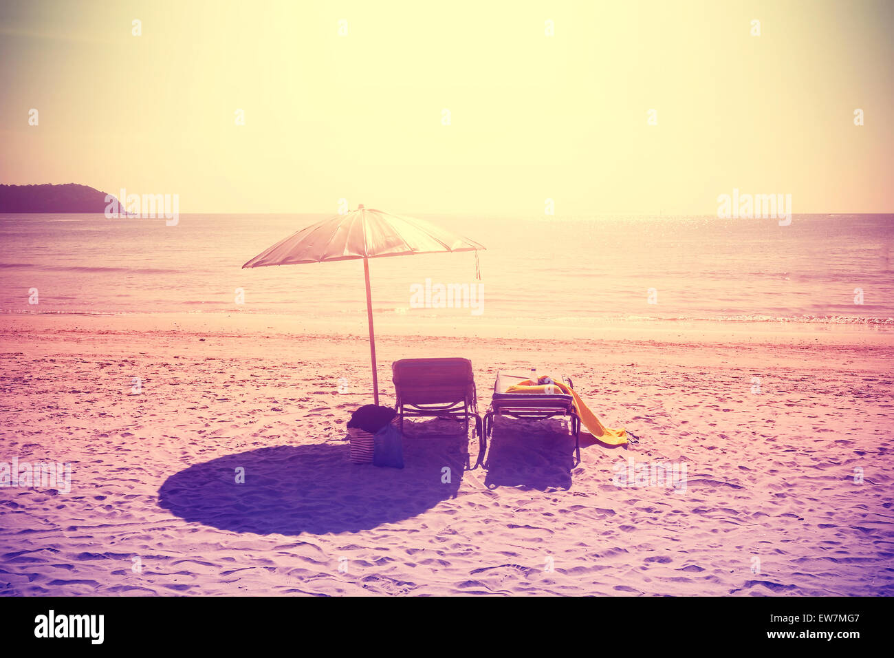 Vintage instagram stylized deckchairs and umbrella at sunset. Concept ...
