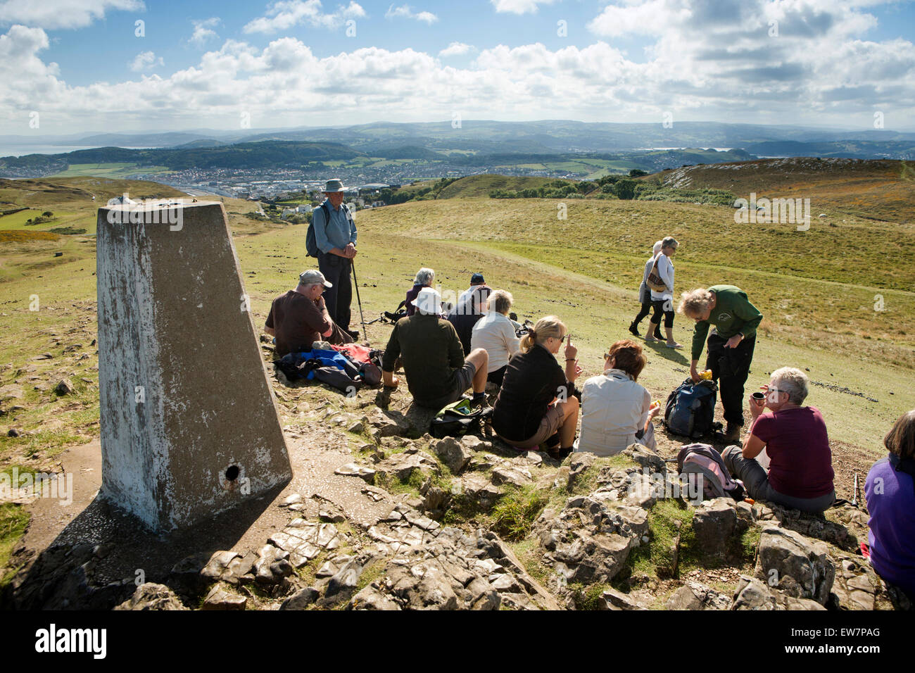 UK, Wales, Conwy, Llandudno, Great Orme Summit, group of walkers resting at trig point Stock ...