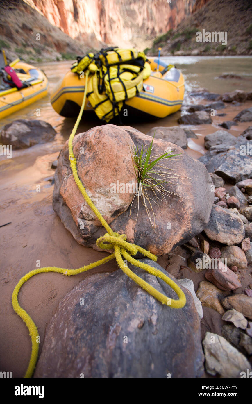 Raft anchored to a rock deep in a canyon Stock Photo - Alamy
