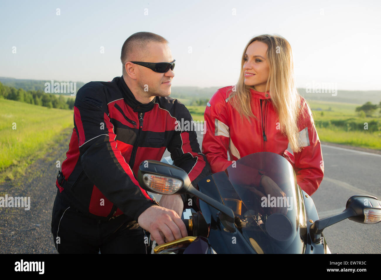 biker man and woman sitting on a motorcycle Stock Photo - Alamy