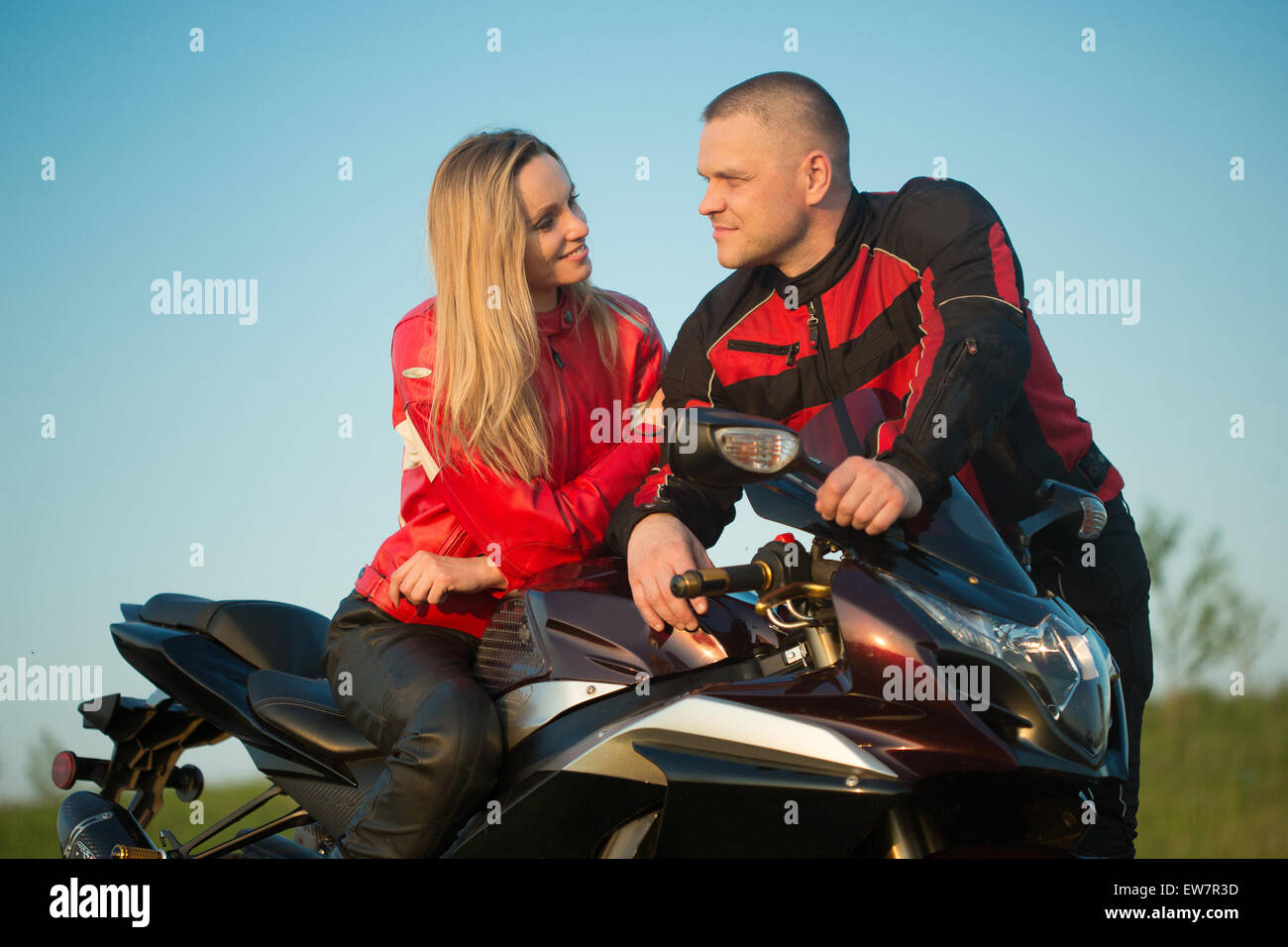 biker man and woman sitting on a motorcycle Stock Photo - Alamy