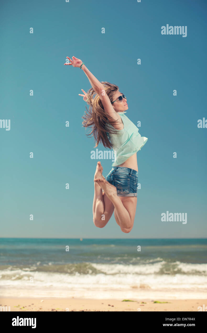 Woman jumping beach hi-res stock photography and images - Alamy
