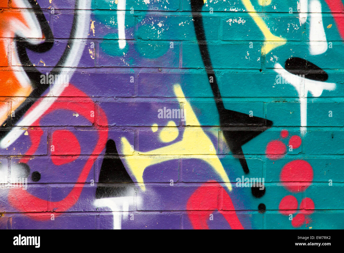 BRIGHTON - MAY 22, 2015. Street art graffiti on an old brick wall in ...