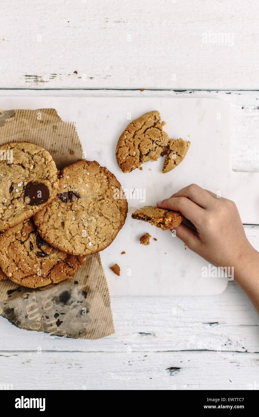 Girl's hand reaching for a cookie Stock Photo - Alamy