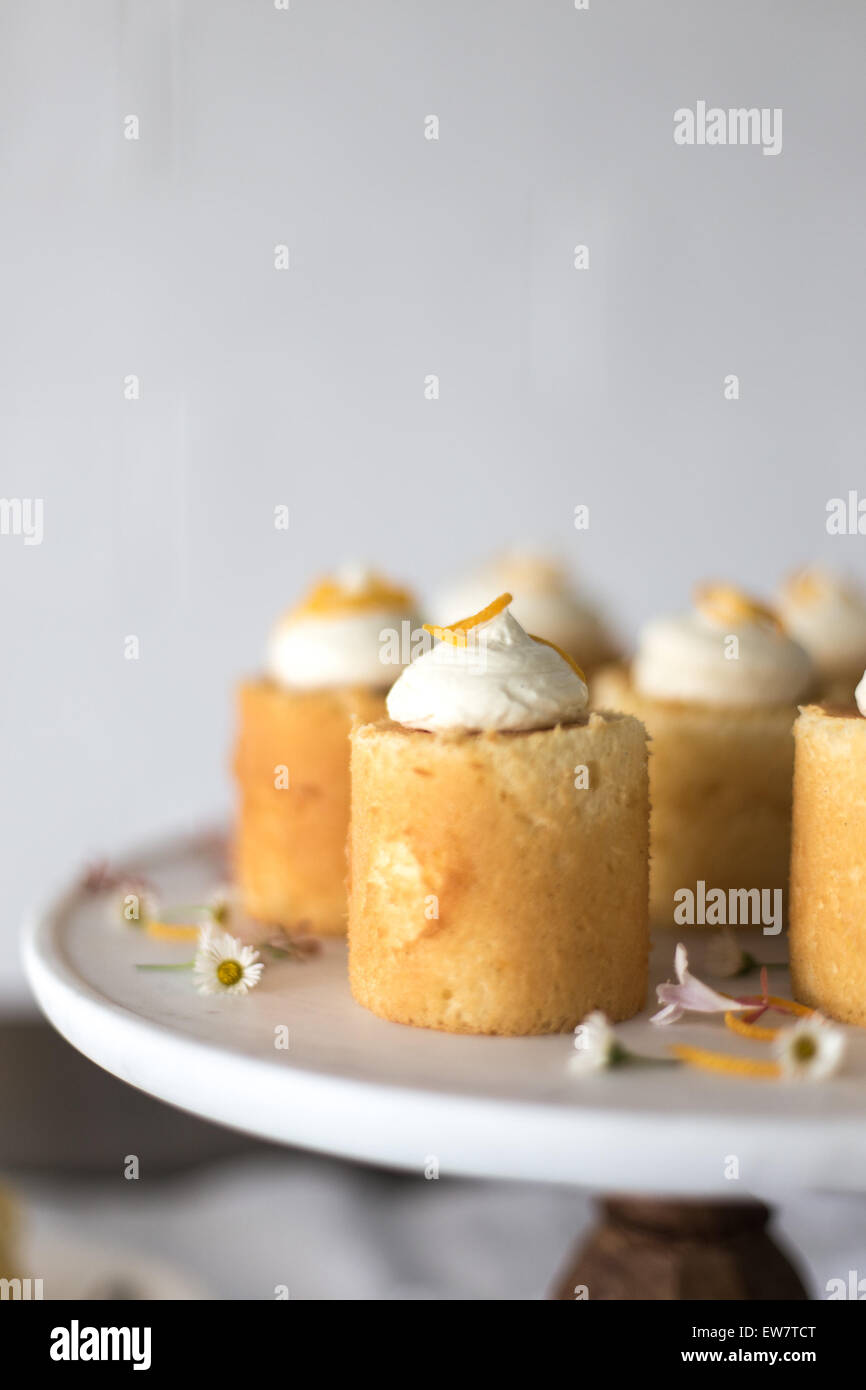 Orange mini sponge cakes on a cake stand Stock Photo - Alamy