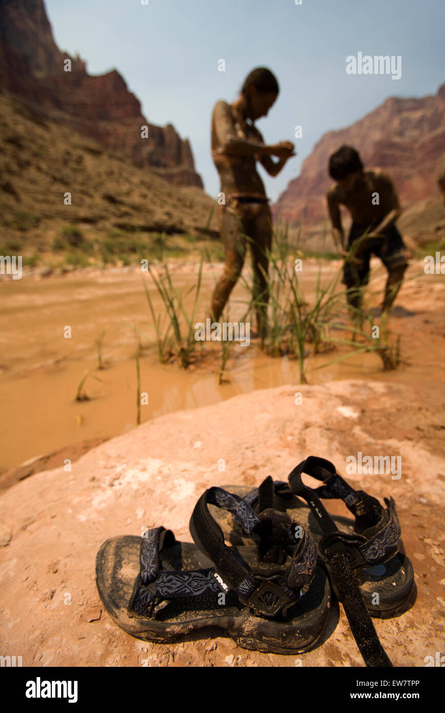 People playing/covered in mud deep in a canyon Stock Photo - Alamy