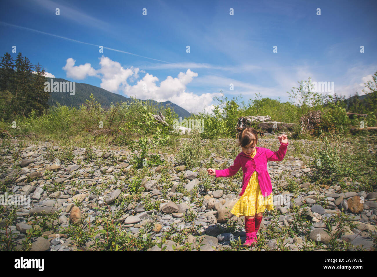 Girl walking on rocks Stock Photo - Alamy