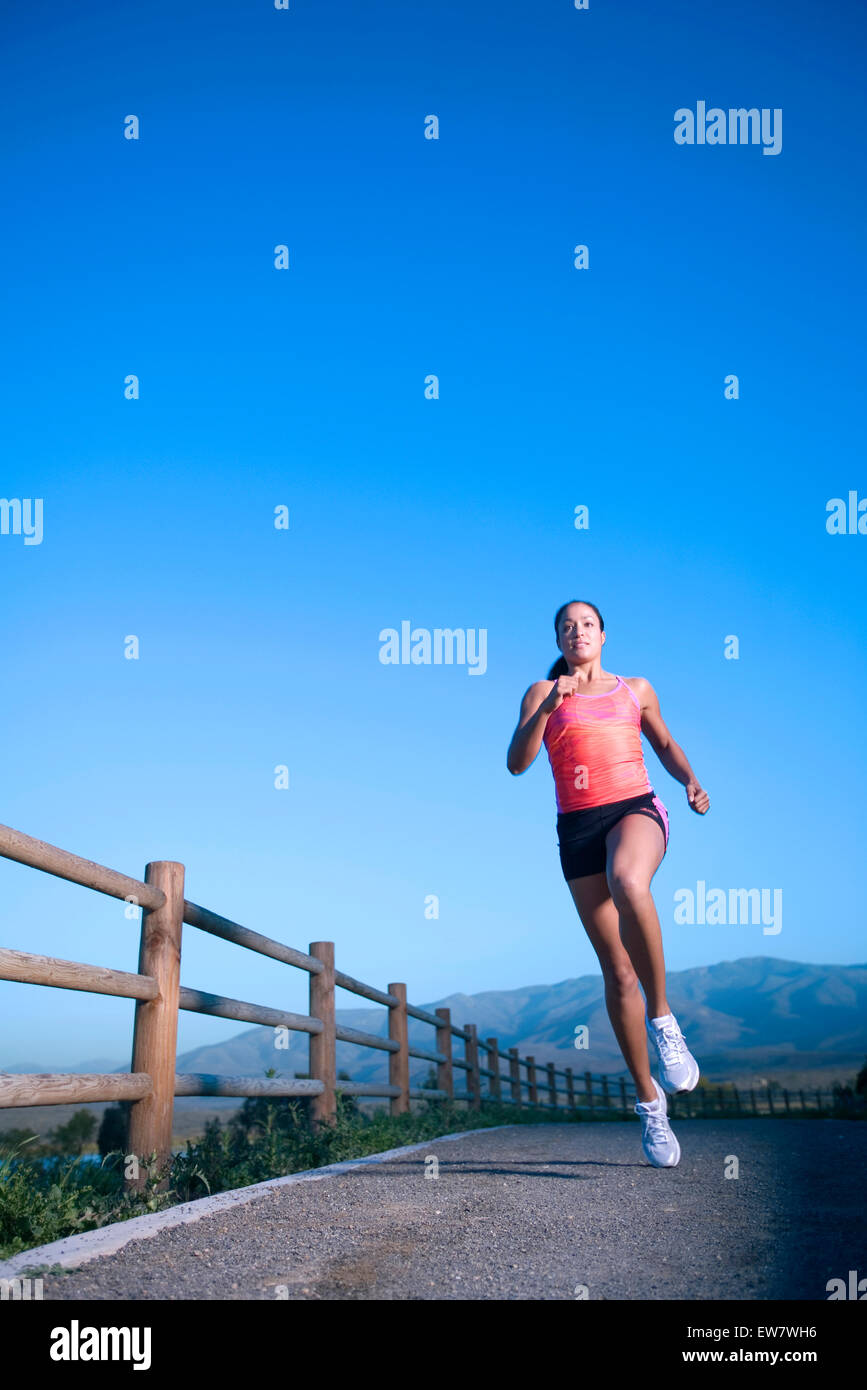 Woman running jumping fence hi-res stock photography and images - Alamy