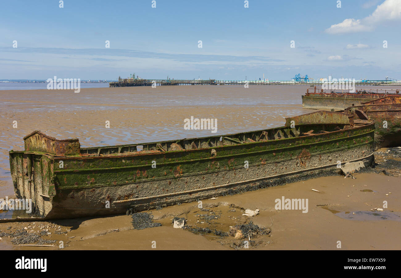The mud banks of the Humber estuary at low tide flanking a disused ship ...