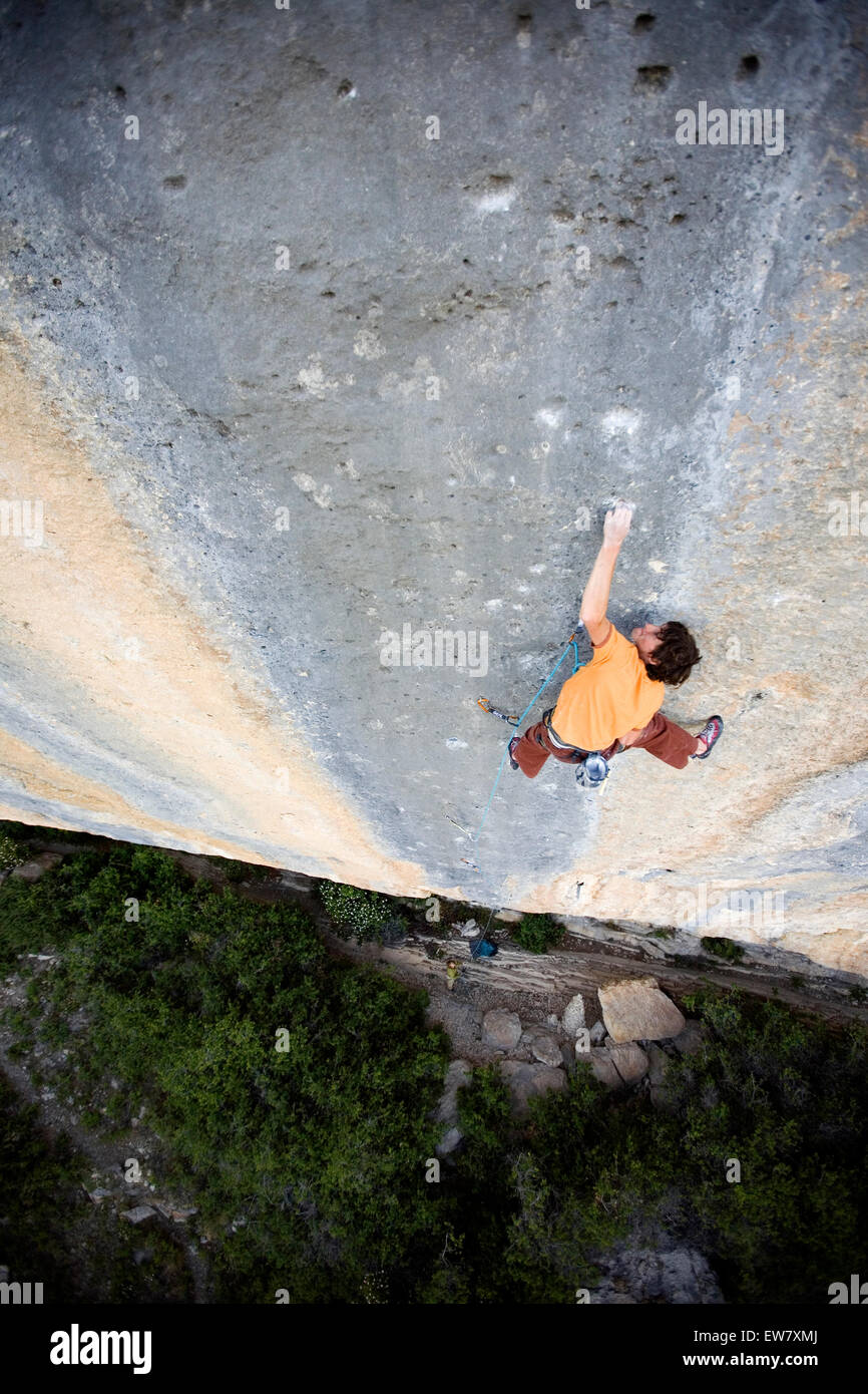 High angle perspective of a man climbing and reaching for a hold Stock ...