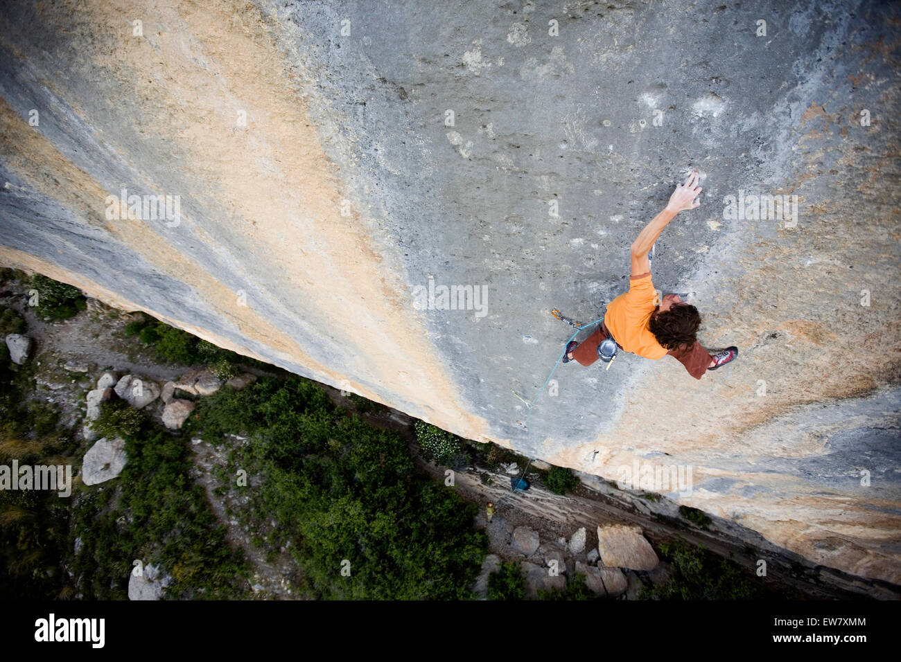 High angle perspective of a man climbing and reaching for a hold Stock ...