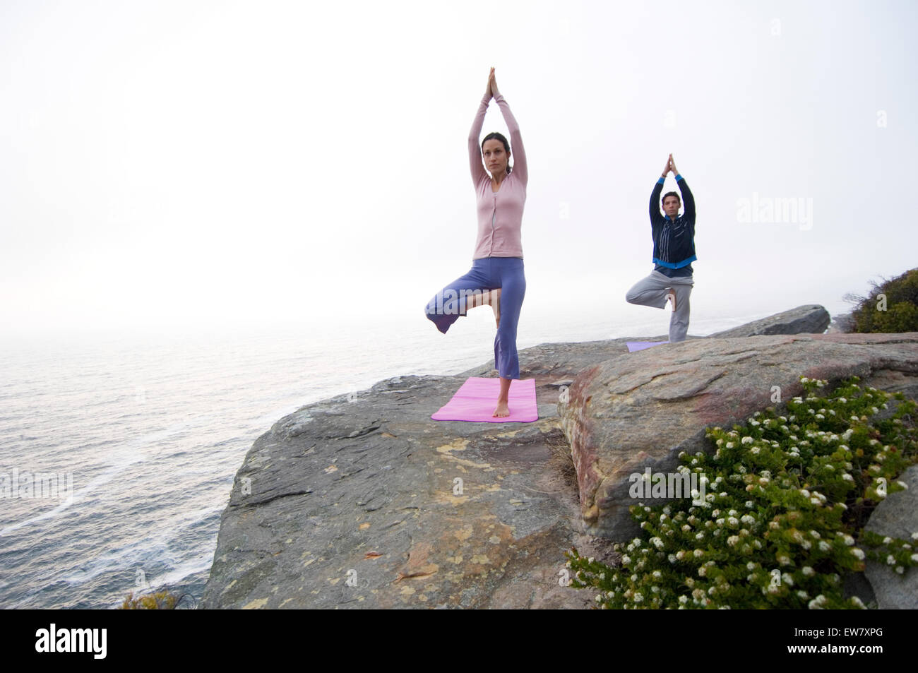 Yoga partners practicing meditation on hi-res stock photography and ...
