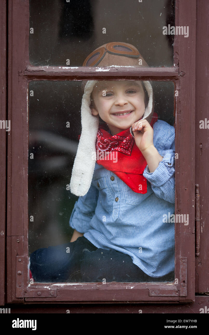 Boy on the window, smiling and drinking tea, having fun Stock Photo - Alamy