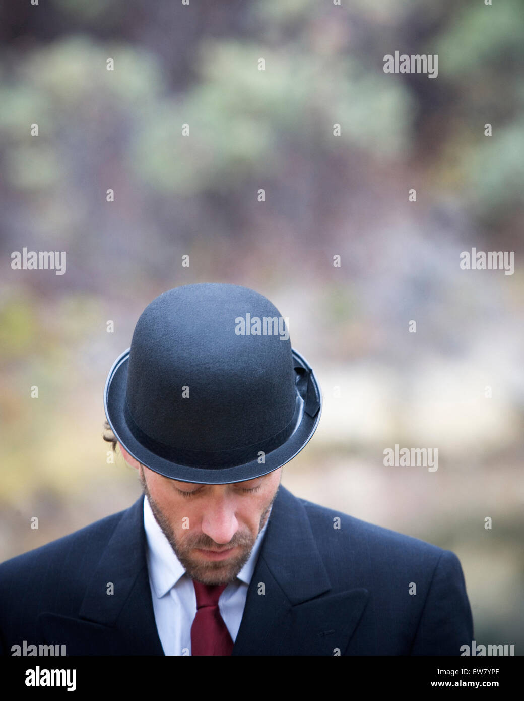 Portrait of a man with his head down wearing a bowler hat Stock Photo ...