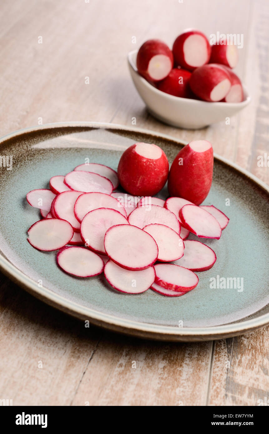 Fresh radishes on a rustic blue plate on a wooden table Stock Photo - Alamy