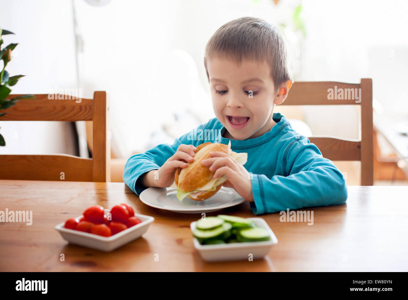 Boy eating sandwich hi-res stock photography and images - Alamy