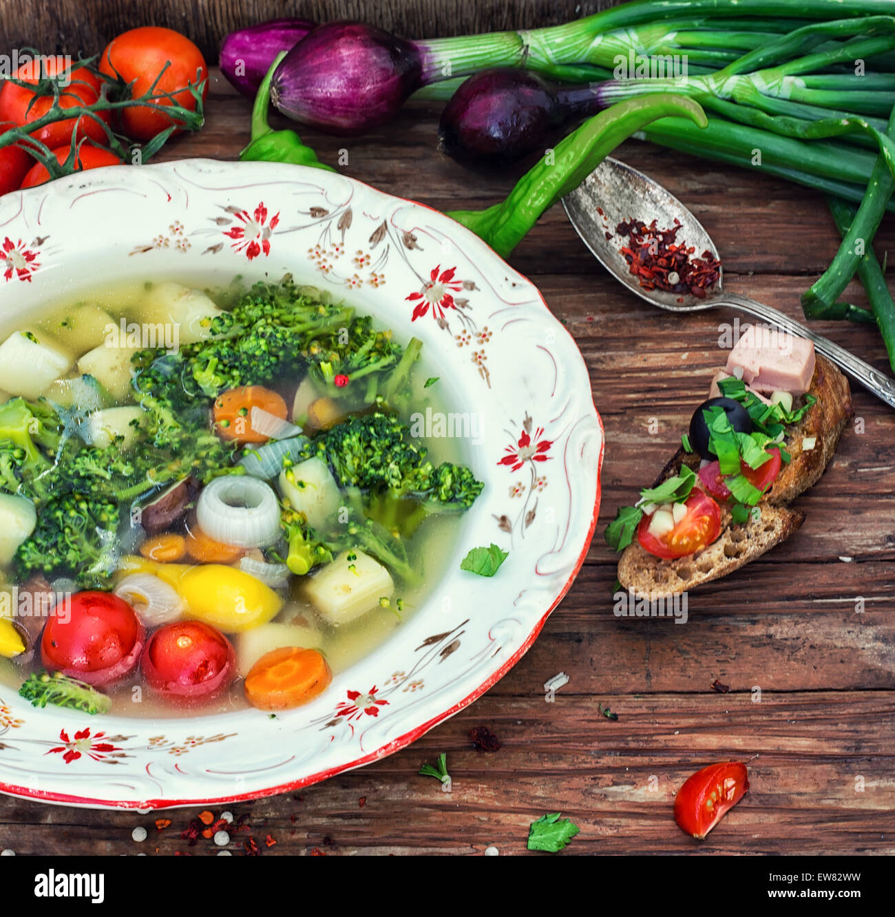 traditional soup of fresh vegetables in a deep dish on the background ...