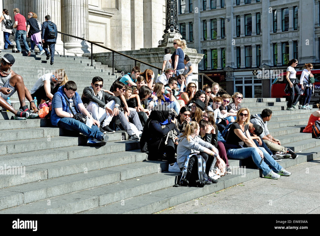 Tourist on the steps of St. Pauls, City of London, England Britain UK ...