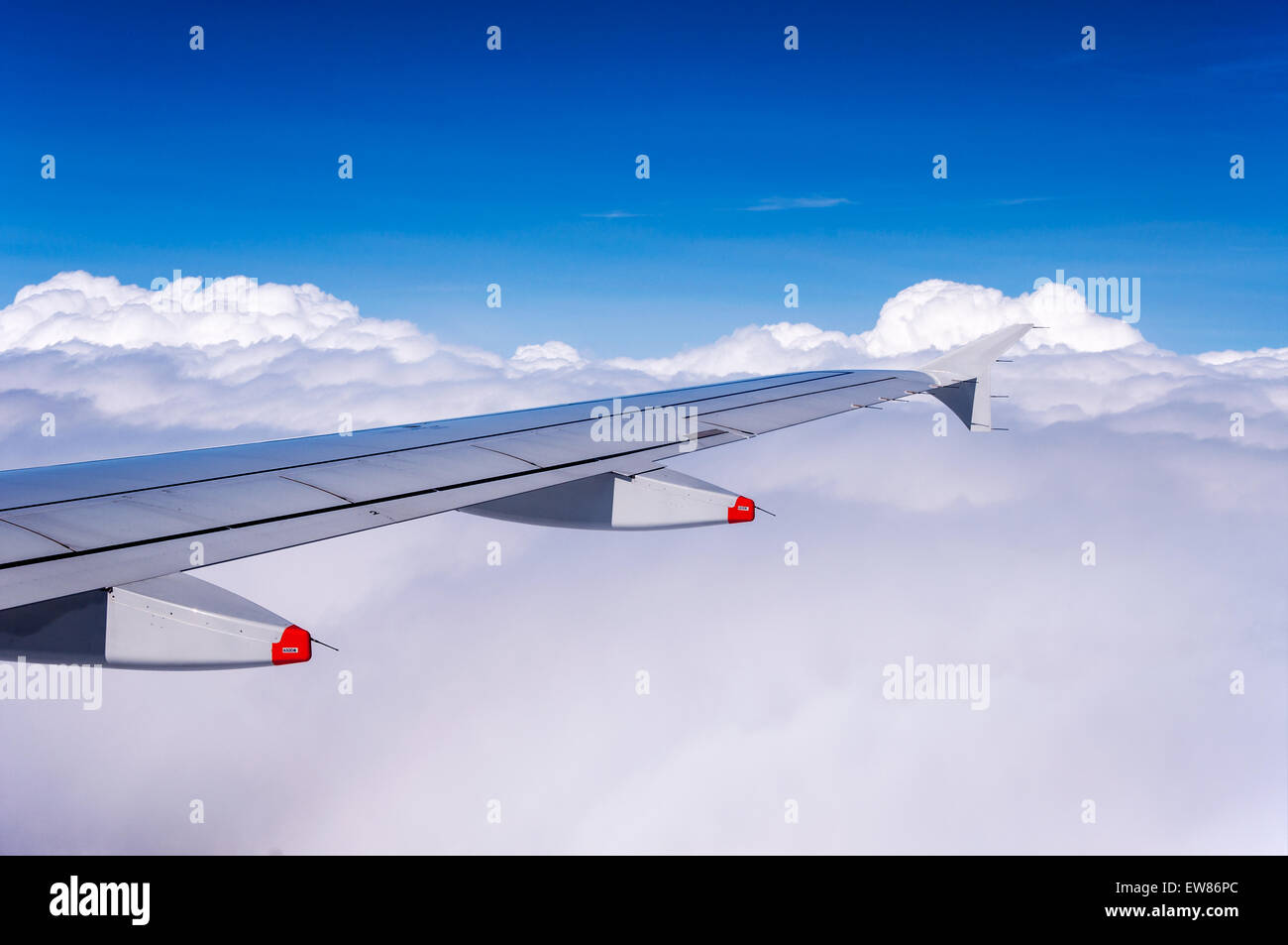 Aircraft wing over clouds with winglet and two anti-shock bodies ...