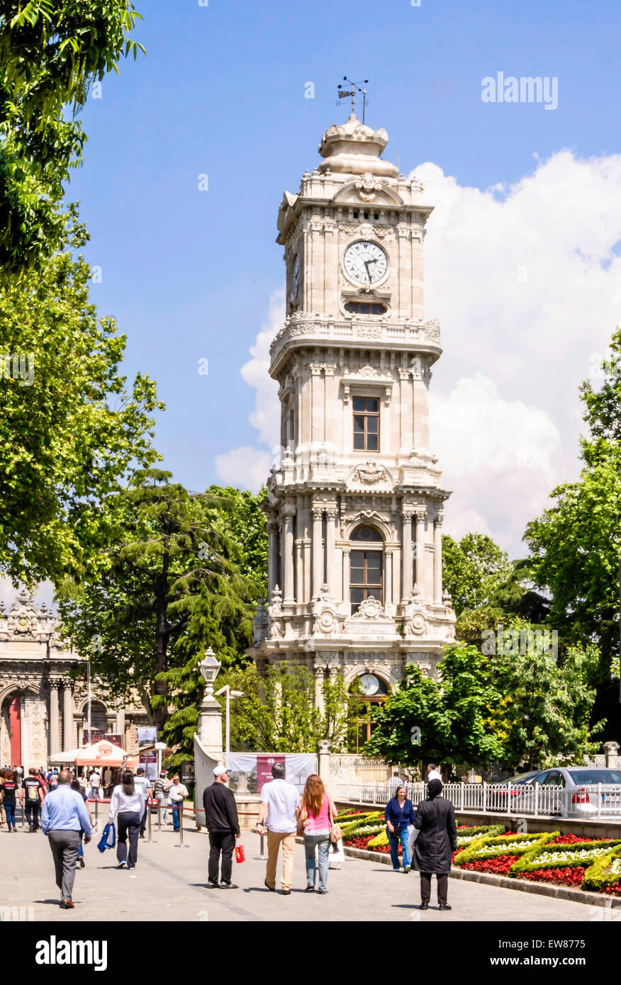 Historic Dolmabahce Clock Tower seems among trees. It is in the garden ...