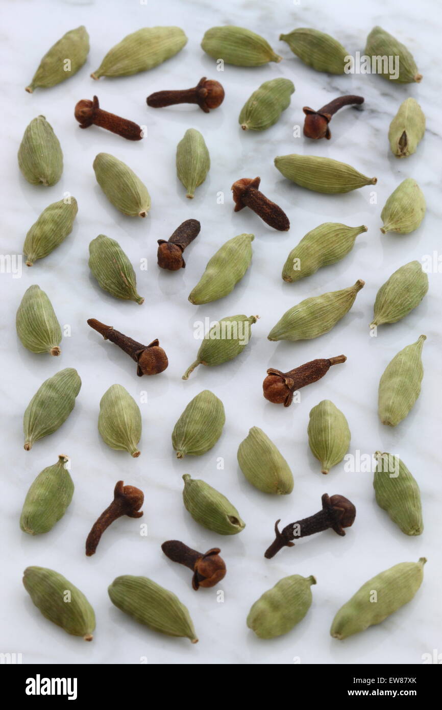 beautiful cardamom and cloves, on carrara marble countertop Stock Photo ...