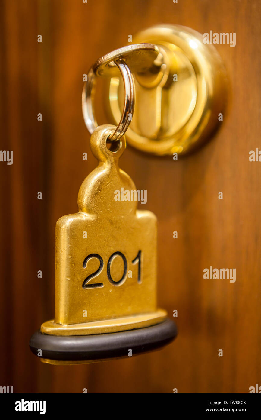Hotel Room Key lying on Bed with keyring golden Stock Photo - Alamy