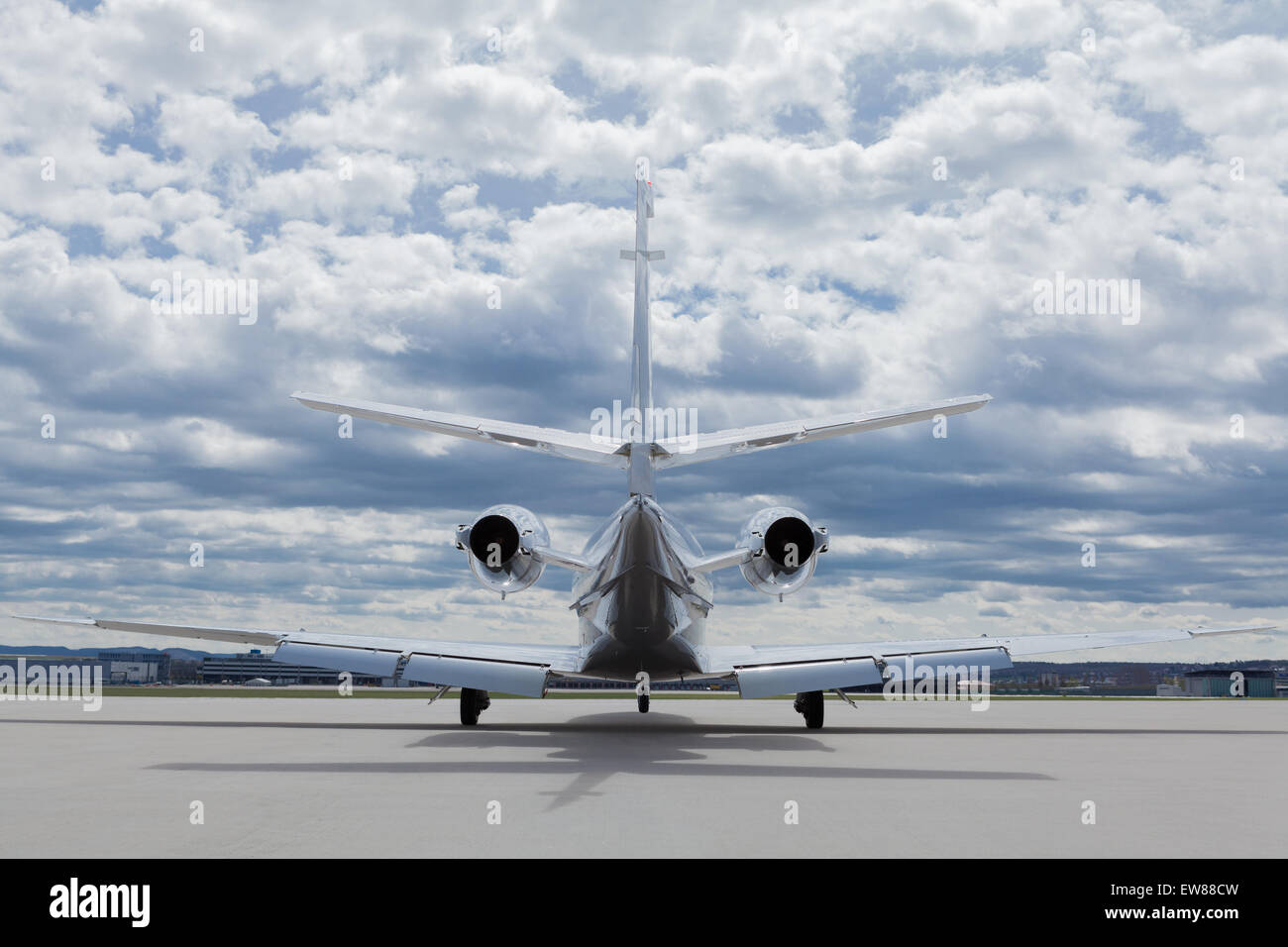 Aircraft learjet Plane in front of the Airport with cloudy sky and sun ...