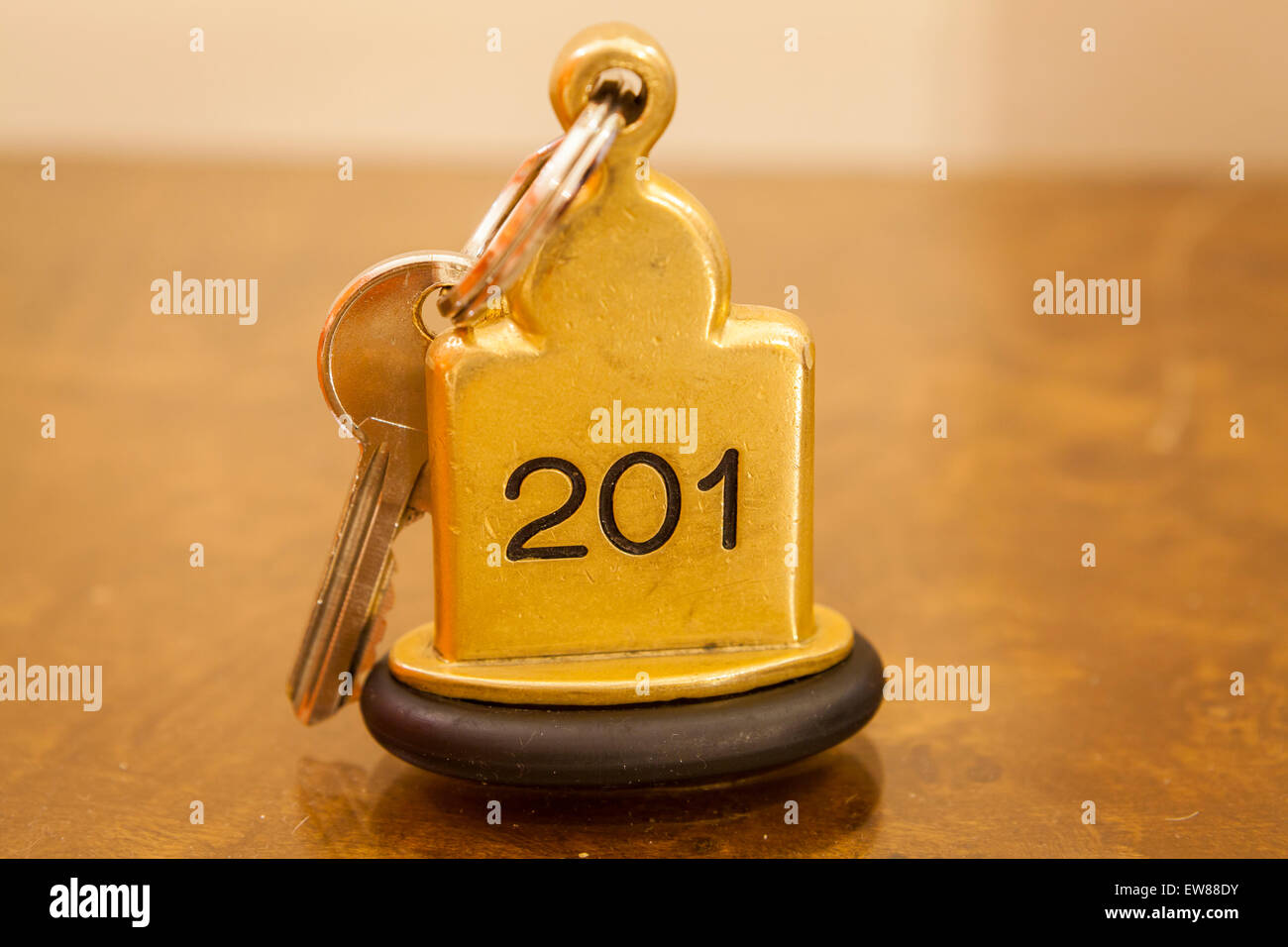 Hotel Room Key lying on Bed with keyring golden Stock Photo - Alamy