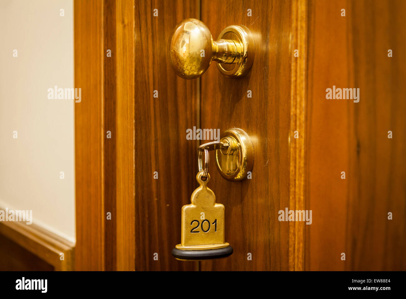 Hotel Room Key lying on Bed with keyring golden Stock Photo - Alamy