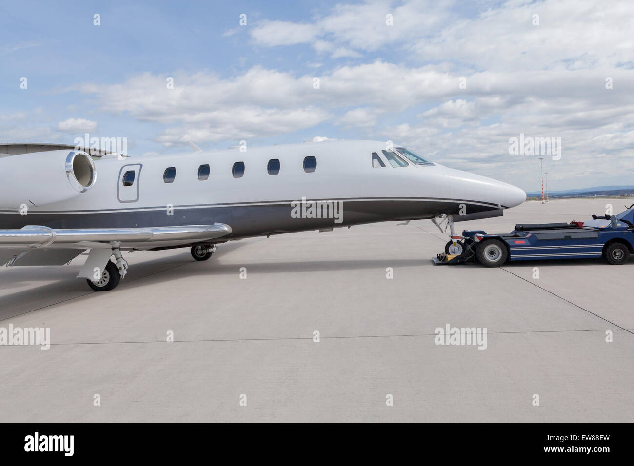 Aircraft learjet Plane in front of the Airport with cloudy sky and sun ...
