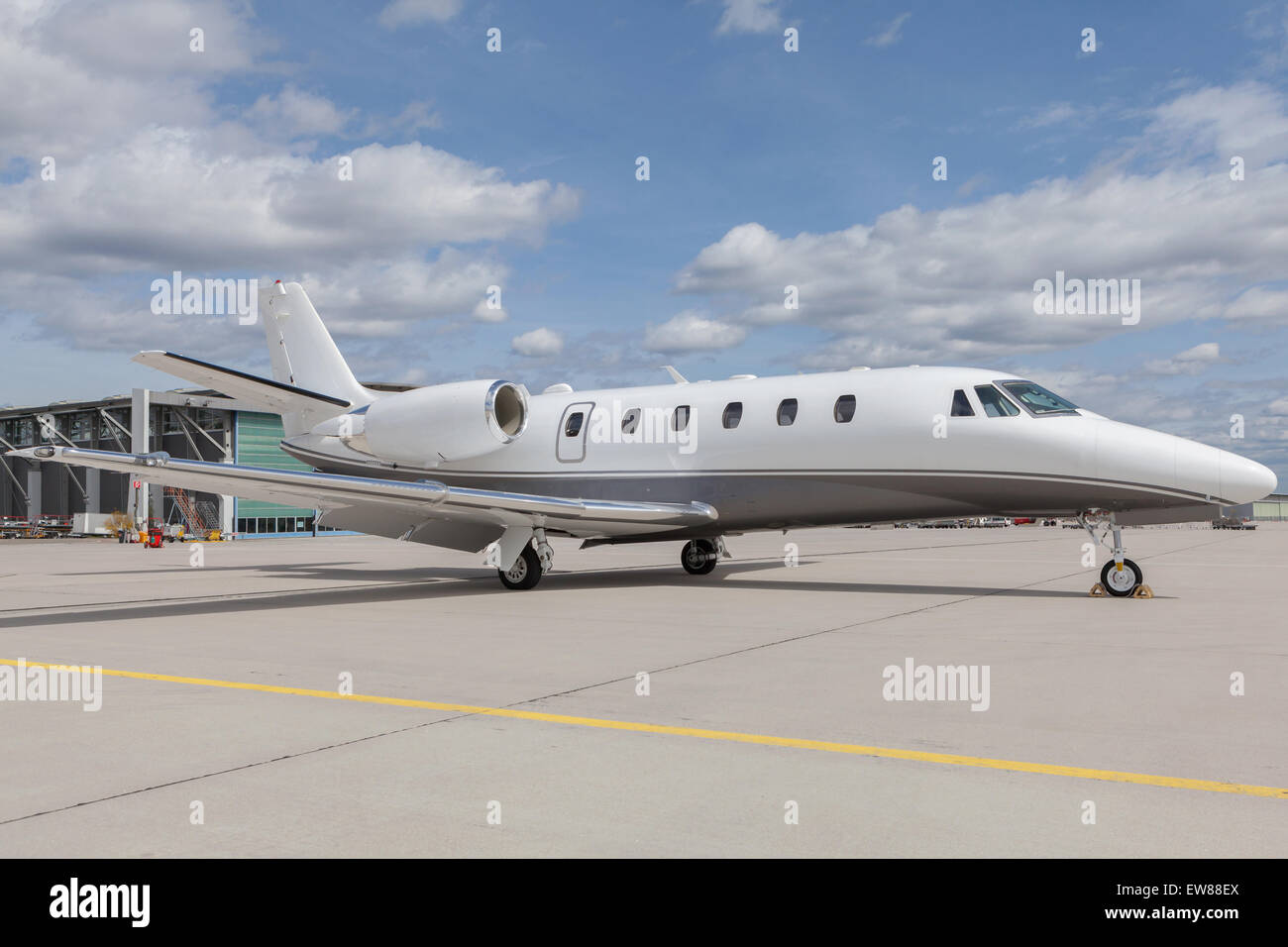 Aircraft learjet Plane in front of the Airport with cloudy sky and sun ...