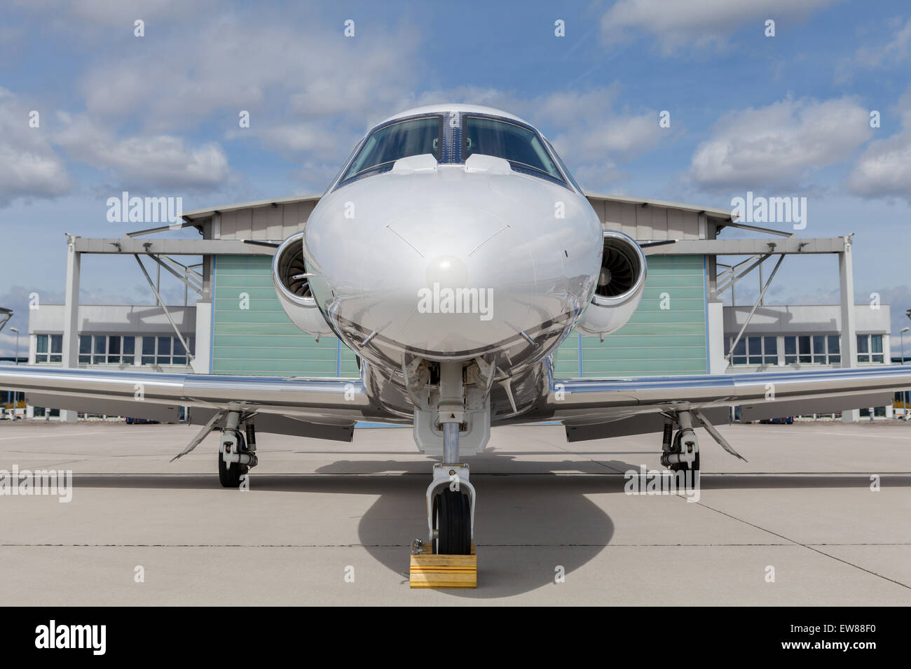 Aircraft learjet Plane in front of the Airport with cloudy sky and sun ...