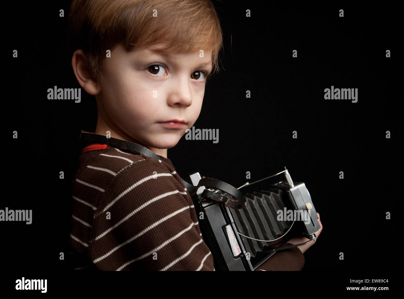 young child holding a instant camera on a white background Stock Photo ...