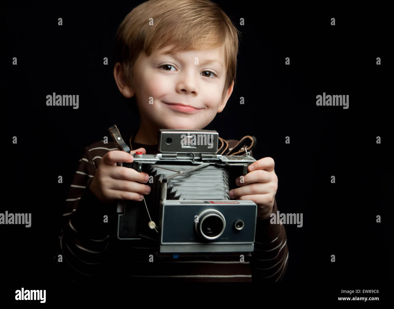 young child holding a instant camera on a white background Stock Photo ...