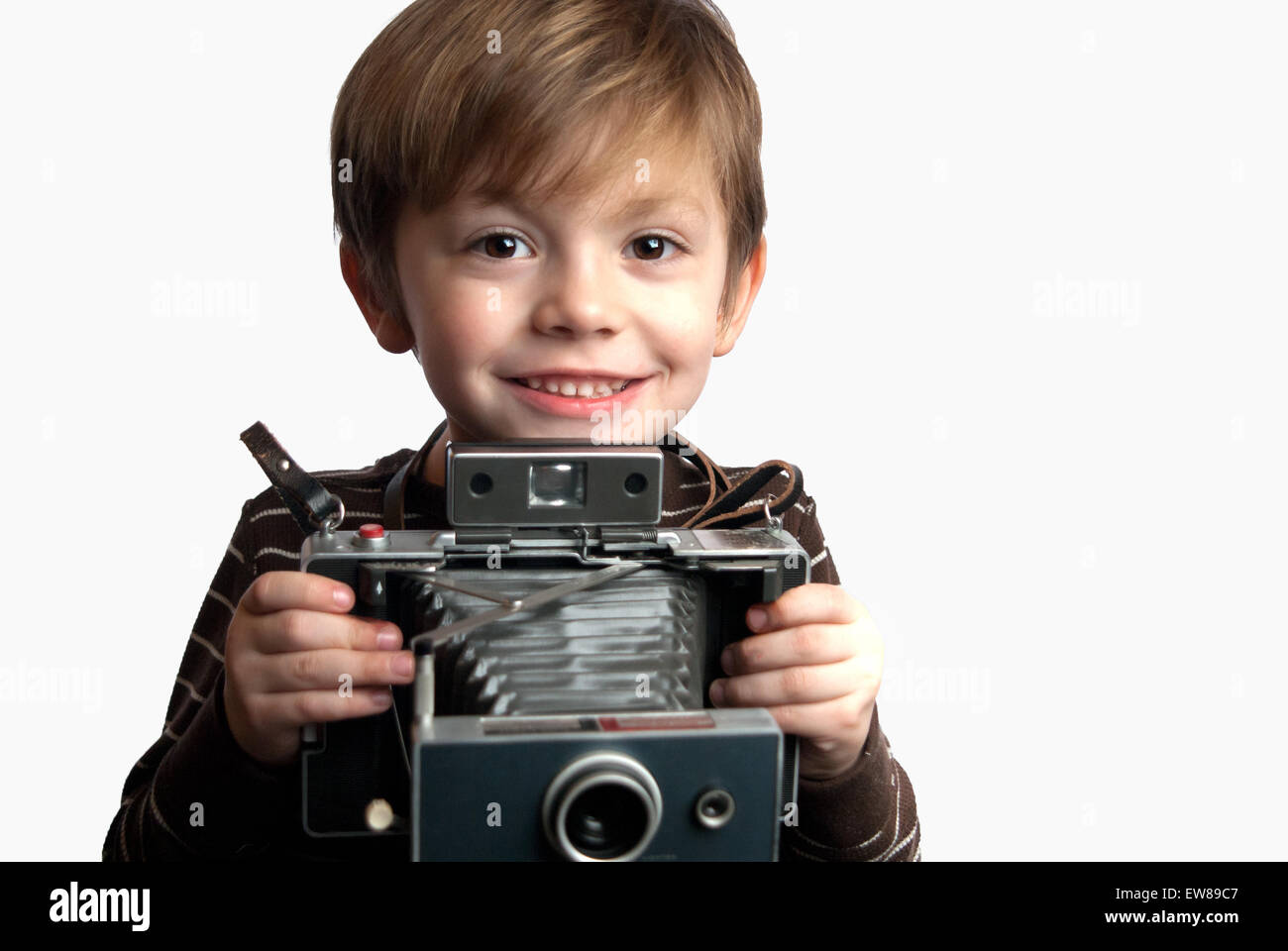 young child holding a instant camera on a white background Stock Photo ...