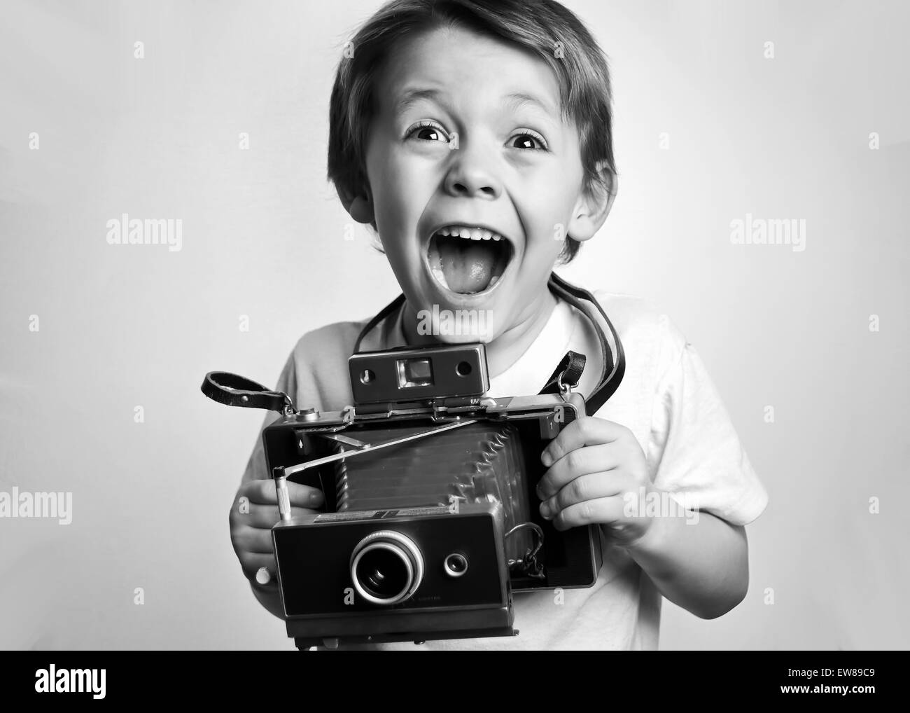 young child holding a instant camera on a white background Stock Photo ...