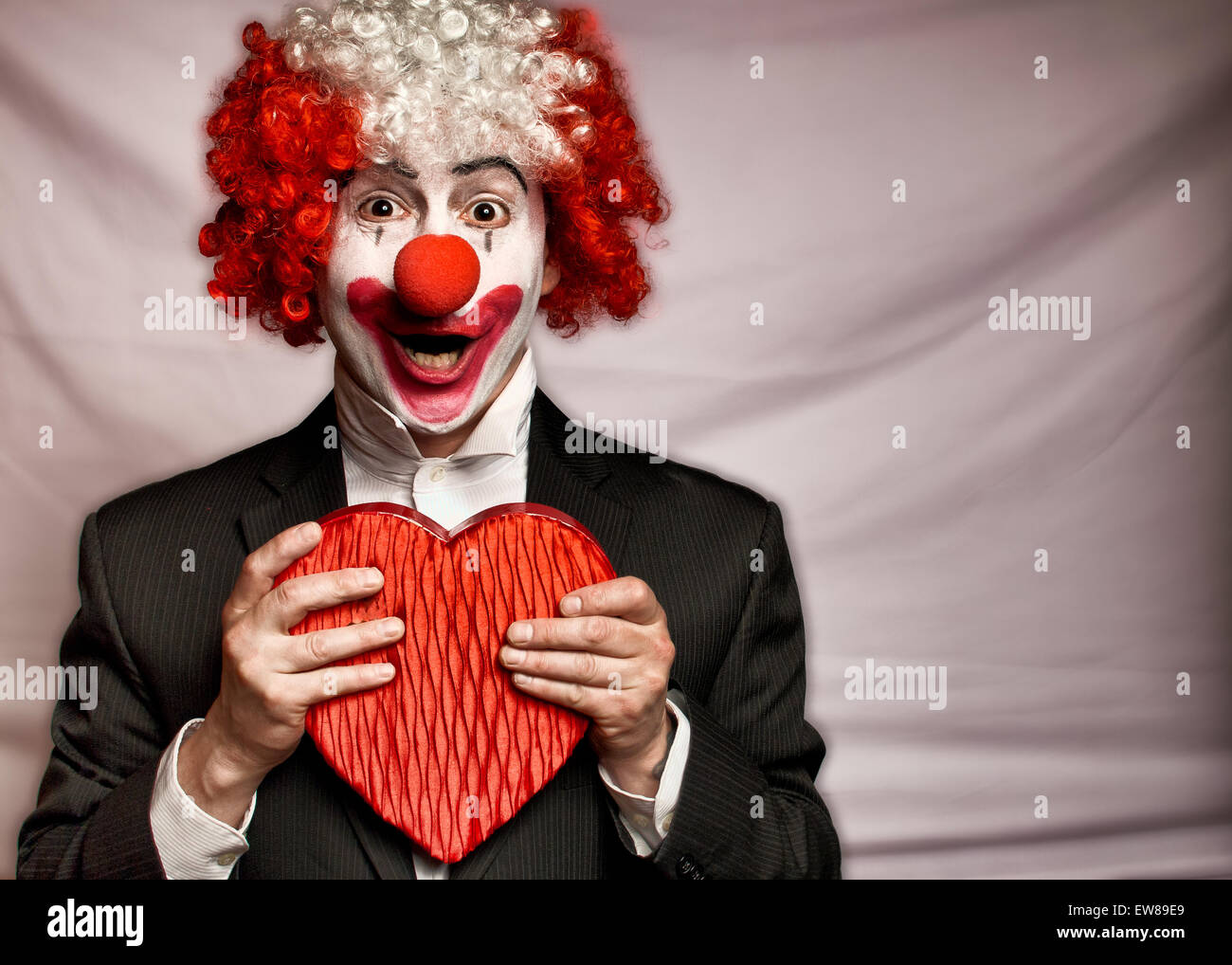 colorful clown with a box of candy on a white background Stock Photo ...