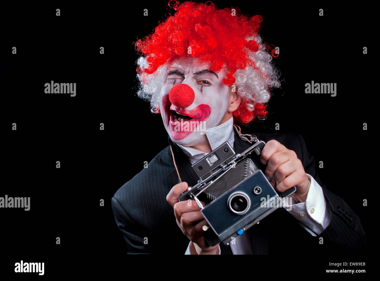 colorful clown with an instant camera on a black background Stock Photo ...
